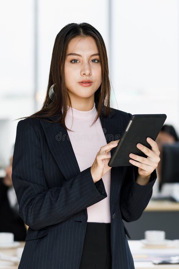 Cute and Beautiful Asian Businesswoman Standing in Office and Using a ...