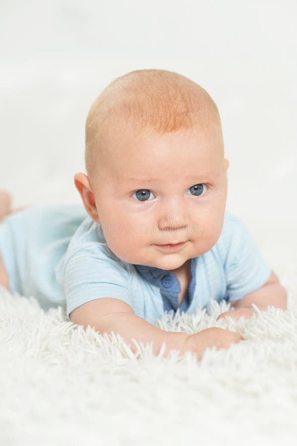 Beautiful baby boy on bed stock photo. Image of studio - 122083082