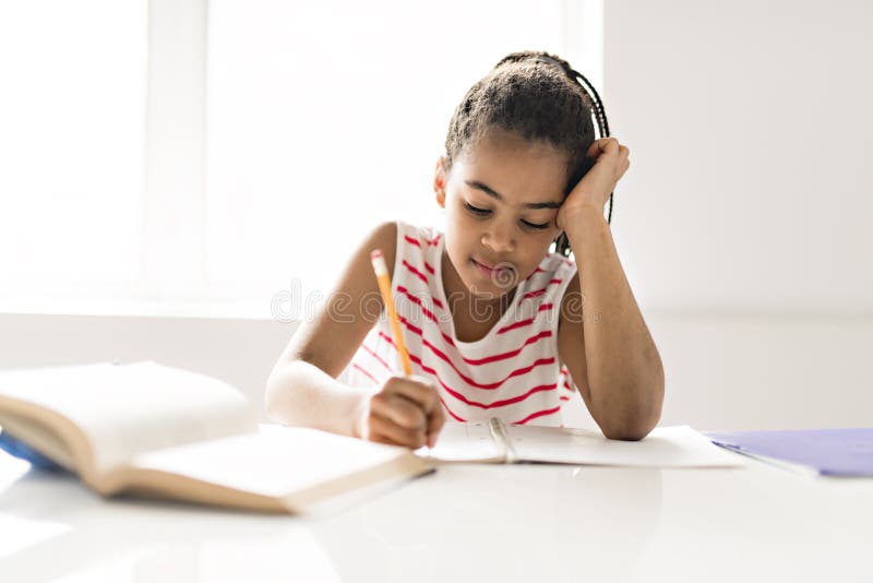 A Cute Black Girl Doing Homework at Home Stock Photo - Image of ...