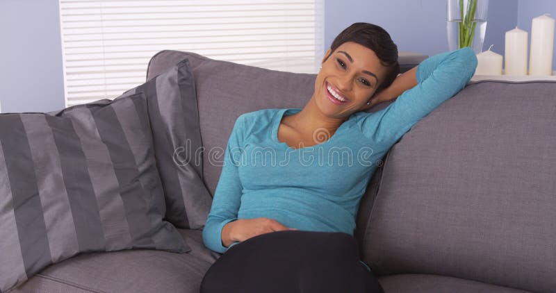Cute Black Woman Resting on Couch Smiling Stock Photo - Image of ...