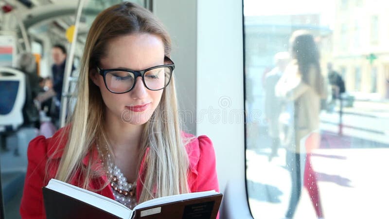 Cute Blond Young Woman Reading Book while Riding Tram Stock Video ...
