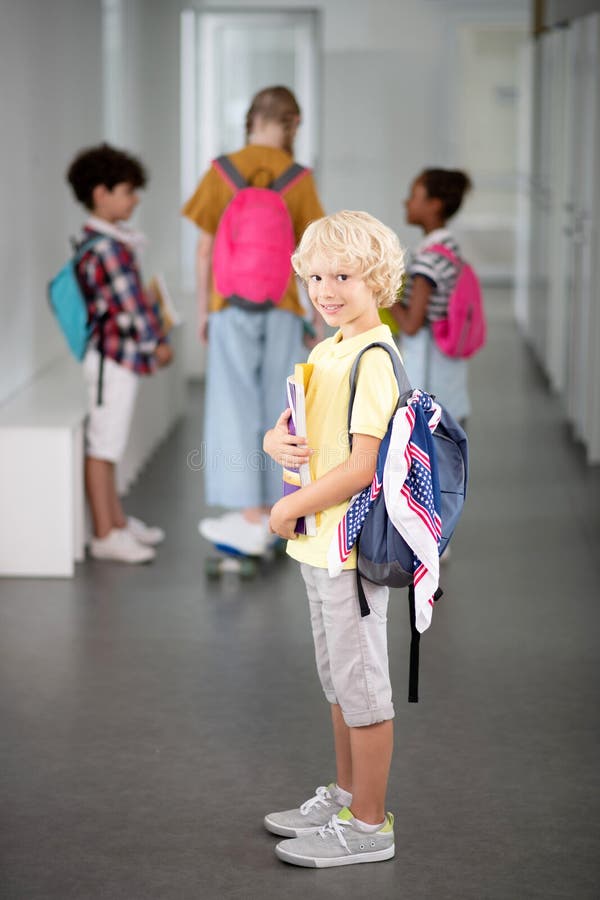 Cute Boy with Backpack Standing in the School Hallway Stock Image ...