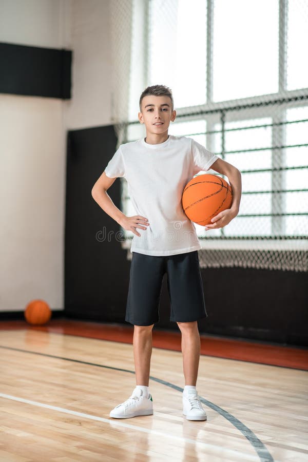 A Cute Boy with a Ball Looking Contented Stock Photo - Image of ...