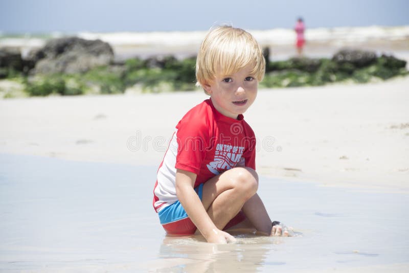 Cute boy at the beach stock image. Image of play, beach - 35325007