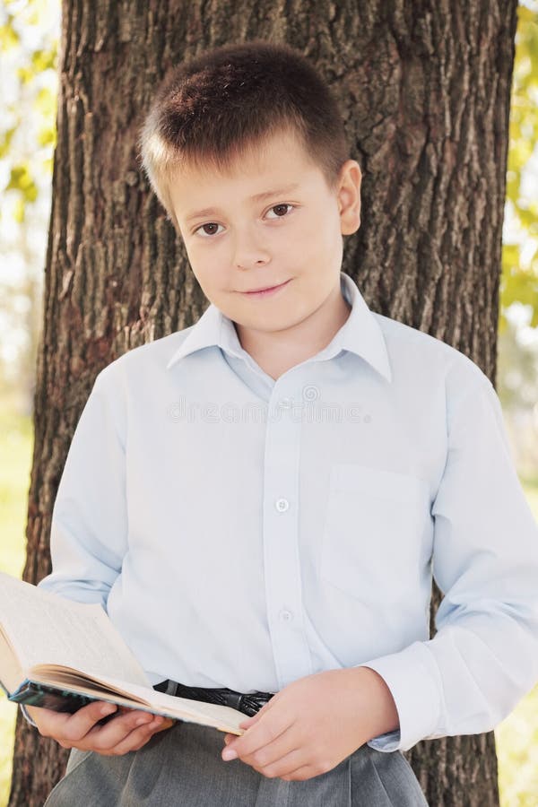 Cute boy with book stock photo. Image of gaze, cute, fall - 16250680