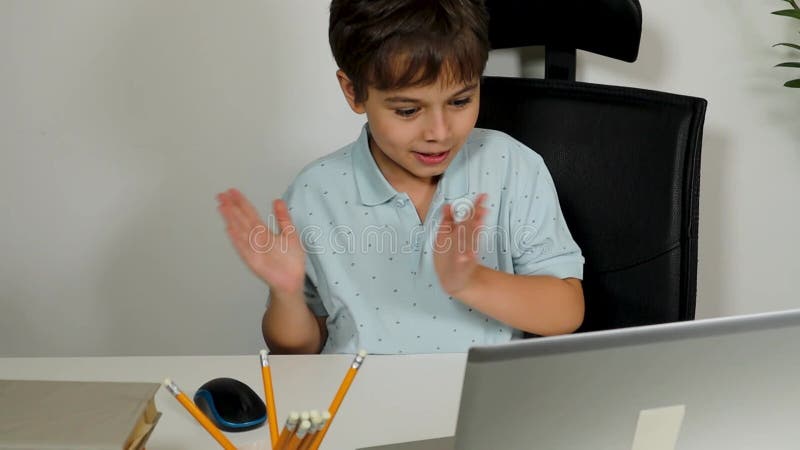 A Cute Boy Clapping His Hands and Looking at Laptop Screen Stock Video ... A Cute Boy Clapping His Hands and Looking at Laptop Screen Stock Video ...