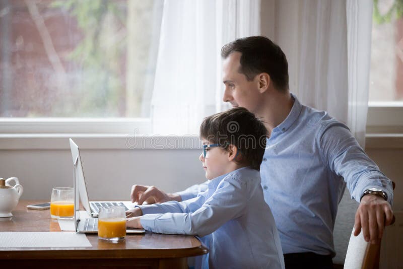 Cute Boy and Dad Working at Laptops in Kitchen Together Stock Photo ...