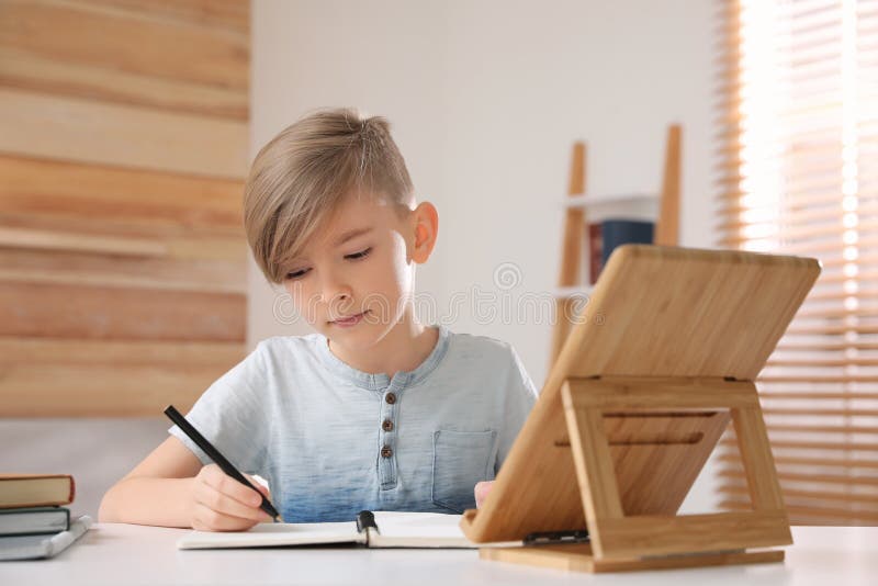 Cute Boy Doing Homework at Table Stock Photo - Image of homework ...