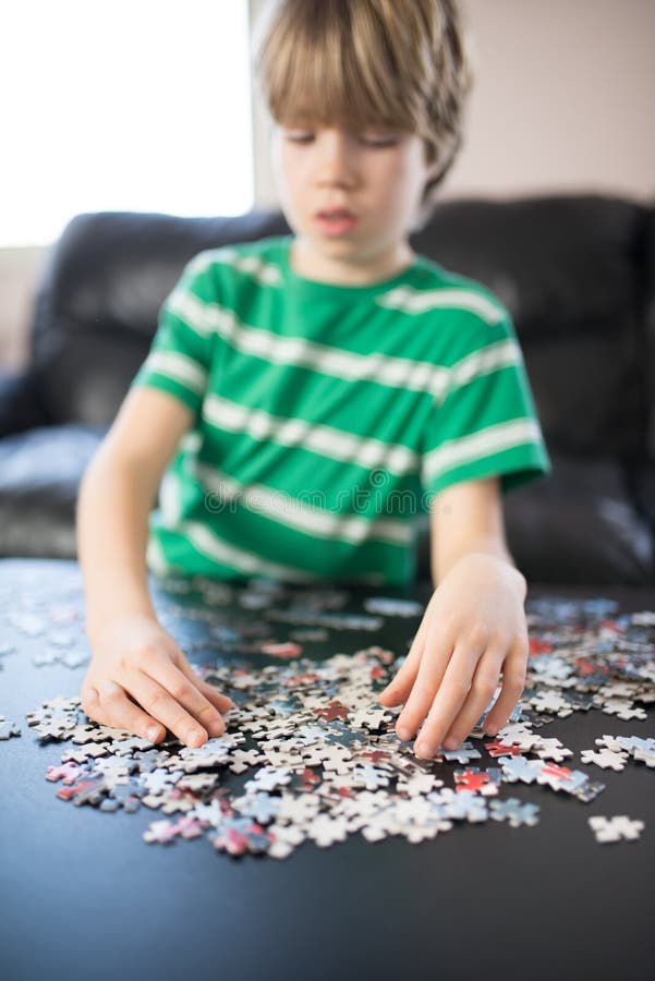 Cute boy doing a puzzle stock photo. Image of blue, education - 87626970