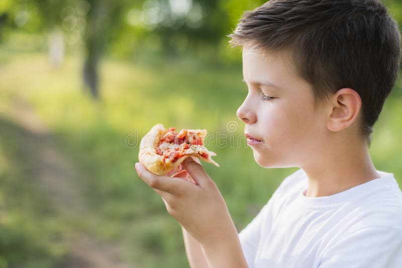 Cute Boy Eating Pizza in Nature on a Sunny Day Stock Photo - Image of ...