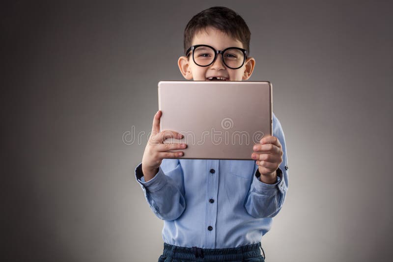 Cute Boy with Electronic Tablet on the Gray Background Stock Photo ...