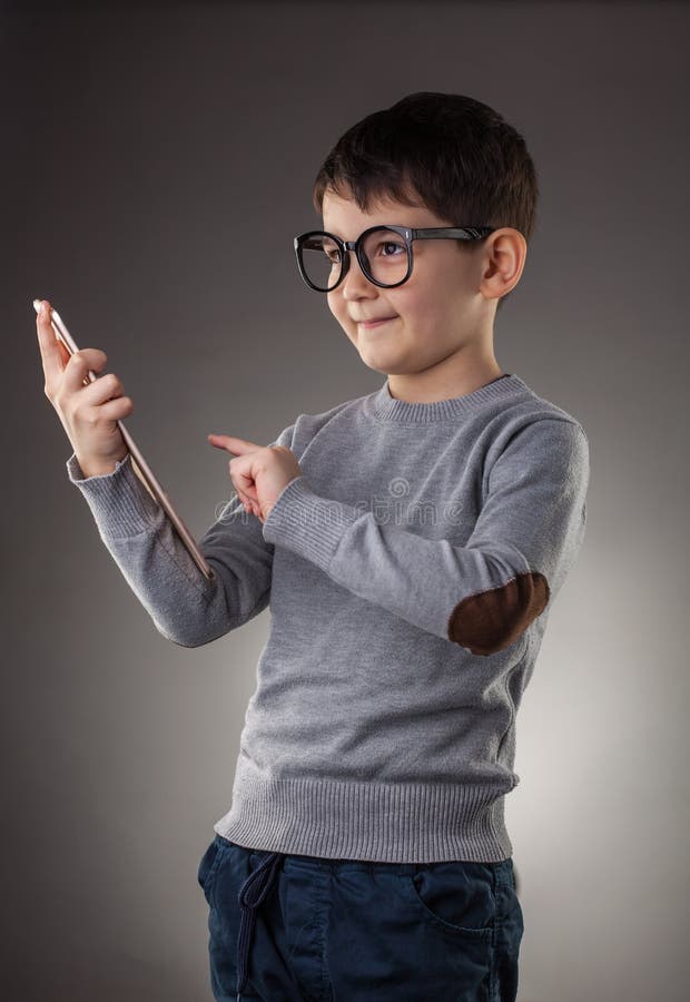 Cute Boy with Electronic Tablet on the Gray Background Stock Photo ...