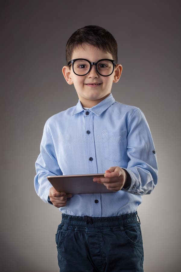 Cute Boy with Electronic Tablet on the Gray Background Stock Photo ...
