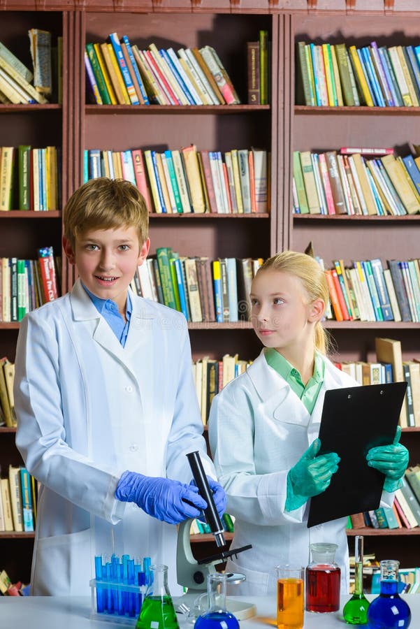 Cute Boy and Girl Doing Biochemistry Research in Stock Image - Image of ...