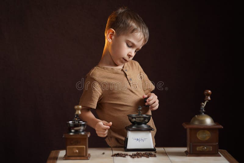 Cute Boy Grinding Coffee on a Retro Coffee Grinder. Stock Photo - Image ...