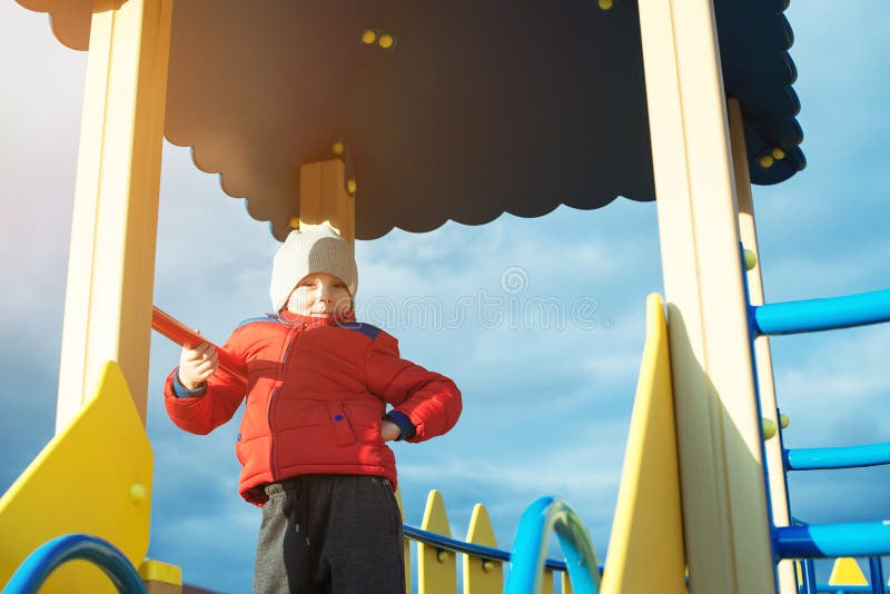 Cute Boy Having Fun on Outdoor Playground in Cold Weather. Stock Photo ...