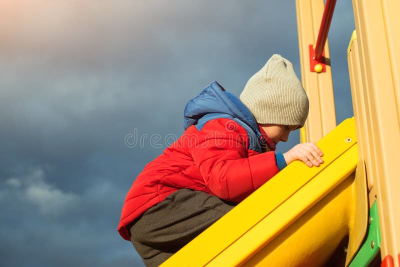 Cute Boy Having Fun on Outdoor Playground in Cold Weather. Stock Image ...