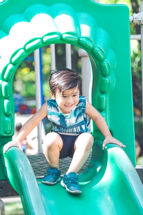 Cute Boy is Having Fun with Slider Playing. Stock Photo - Image of ...