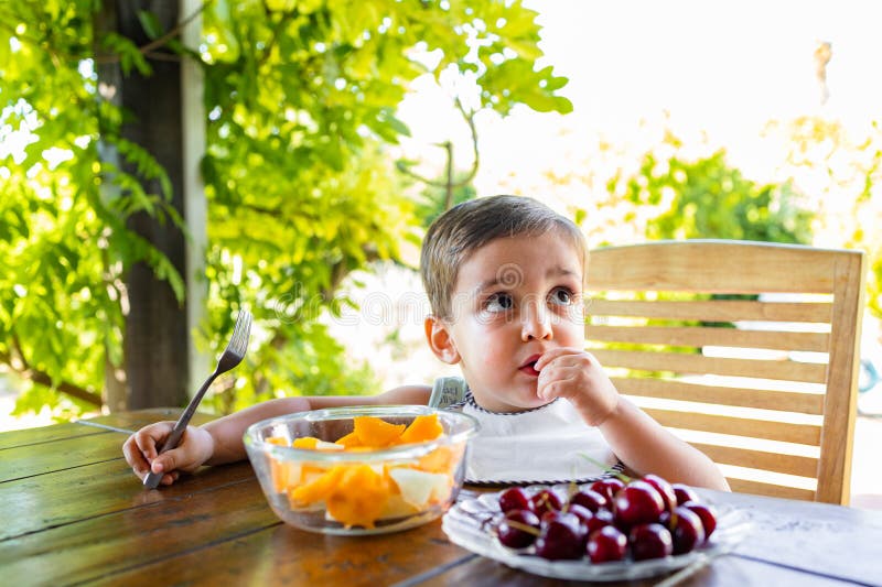Cute Boy Having a Healthy Fruit Snack Outdoors Stock Photo - Image of ...