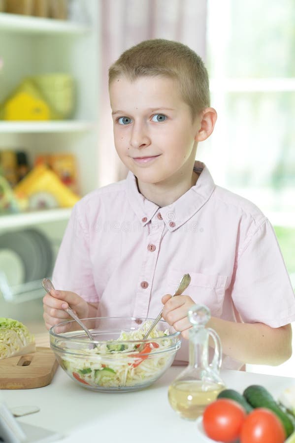 Cute Boy Making Dinner on Kitchen Table at Home Stock Photo - Image of ...