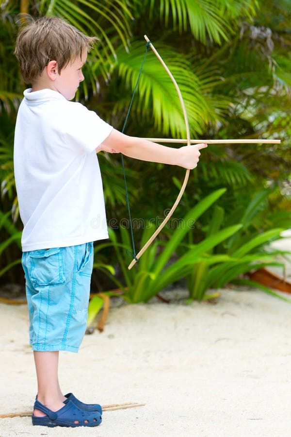Cute Boy Playing with Bow and Arrows Stock Image - Image of closeup ...