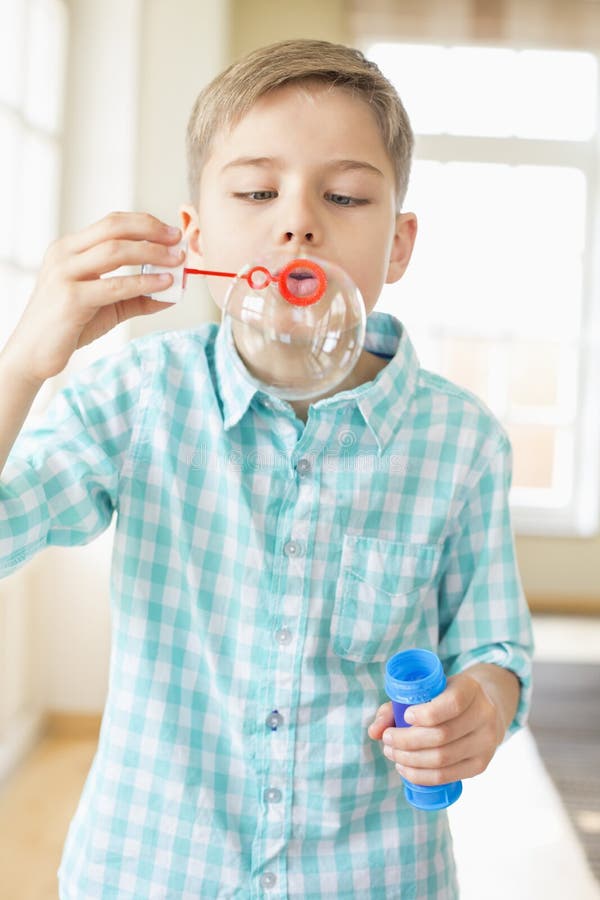 Siblings Playing Hand-held Video Game at Home Stock Image - Image of ...