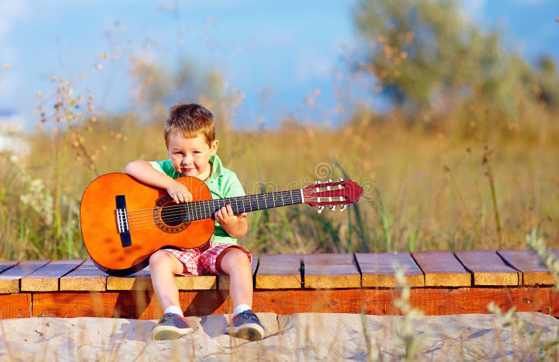 Young Kid Playing Guitar on Beach Stock Image - Image of play, person ...