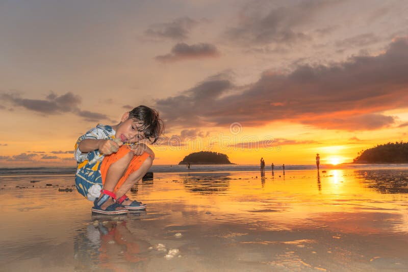 A Cute Boy Playing Sand on the Beach Stock Image - Image of cute ...