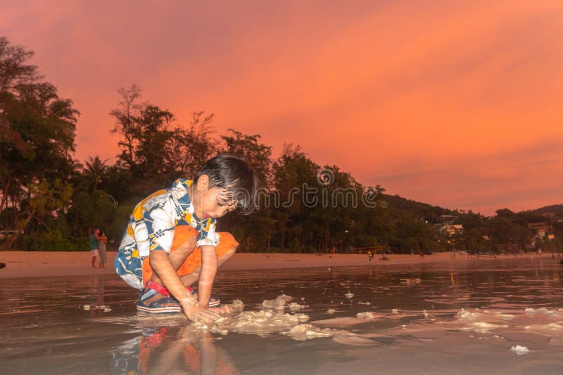 A Cute Boy Playing Sand in Sunset Stock Image - Image of dark ...