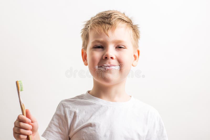 Cute Boy Posing with Bamboo Toothbrush in His Mouth, Child Brushes His ...