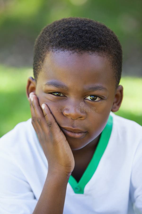 Cute Boy Pouting at the Camera in the Park Stock Photo - Image of park ...