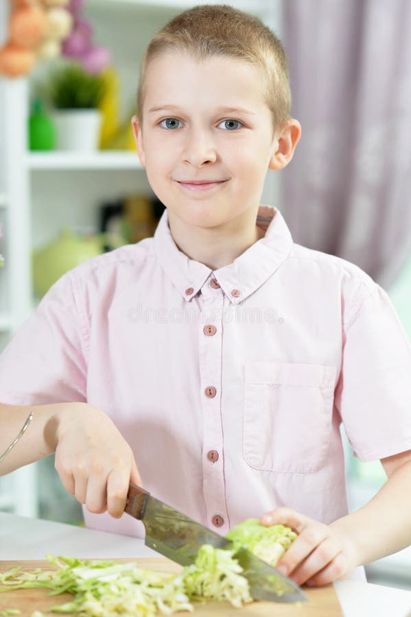 Cute Boy Preparing Salad on Kitchen Table at Home Stock Photo - Image ...