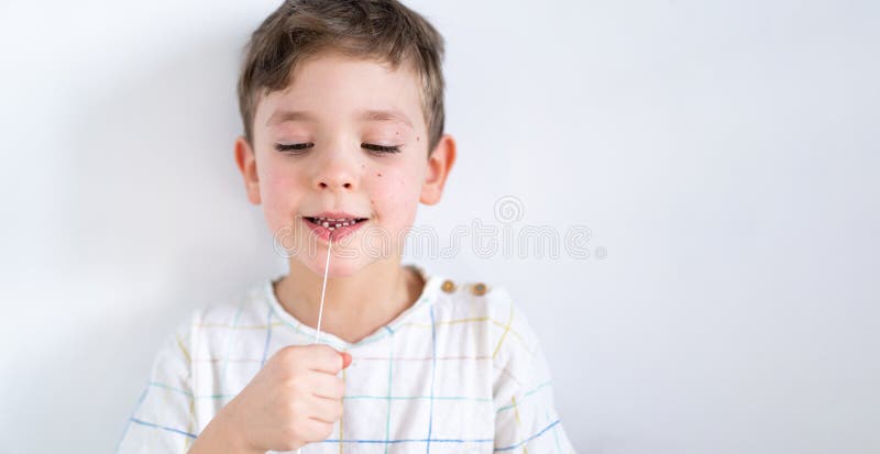 Cute Boy Pulling Loose Tooth Using a Dental Floss. Process of Removing ...