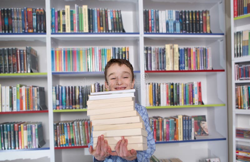 Cute Boy Reading Book in Library Stock Photo - Image of librarian ...