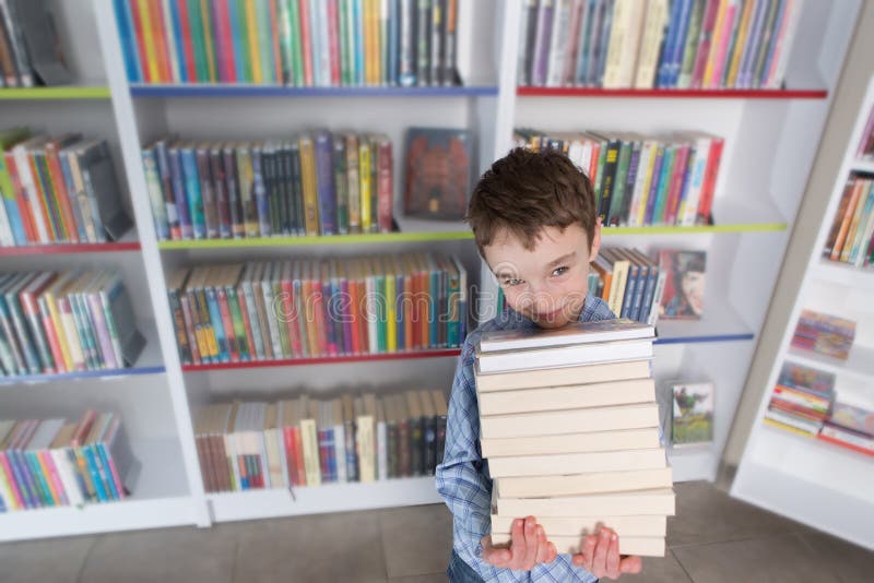 Cute Boy Reading Book in Library Stock Photo - Image of elementary ...