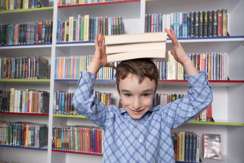 Cute Boy Reading Book in Library Stock Image - Image of read, desk ...