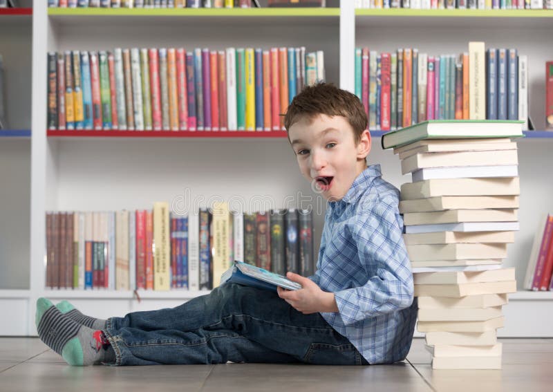 Cute Boy Reading Book in Library Stock Image - Image of development ...