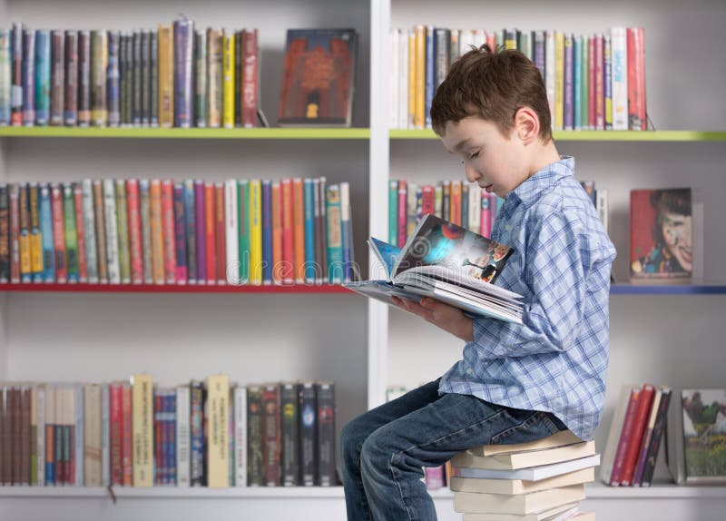 Cute Boy Reading Book in Library Stock Image - Image of computer ...