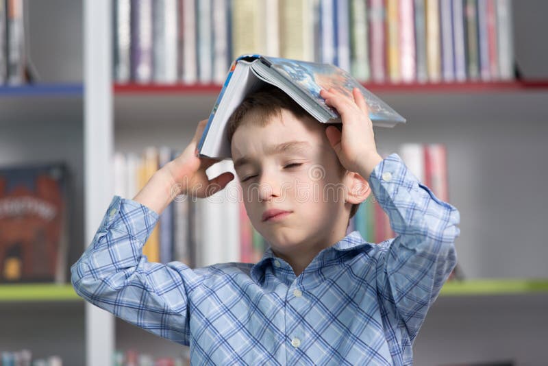 Cute Boy Reading Book in Library Stock Image - Image of reading, laptop ...