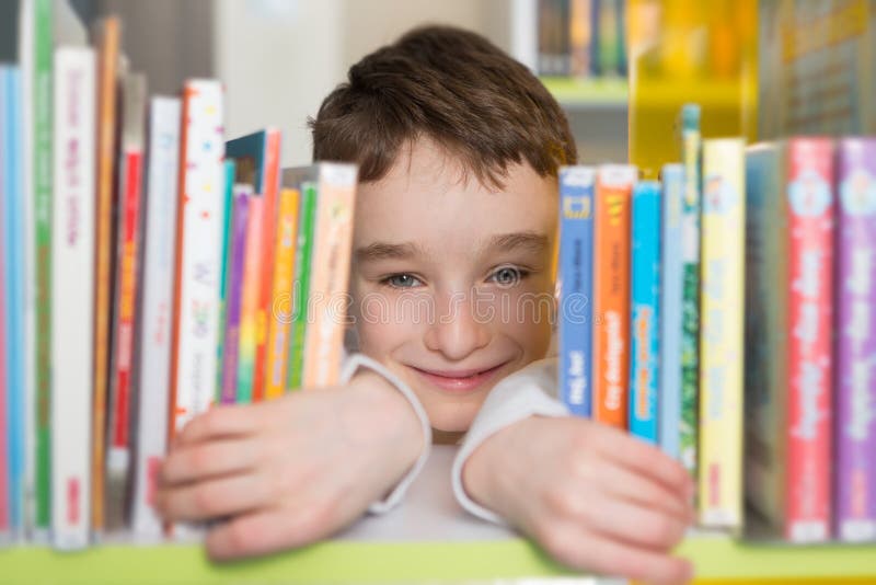 Cute Boy Reading Book in Library Stock Photo - Image of college, desk ...