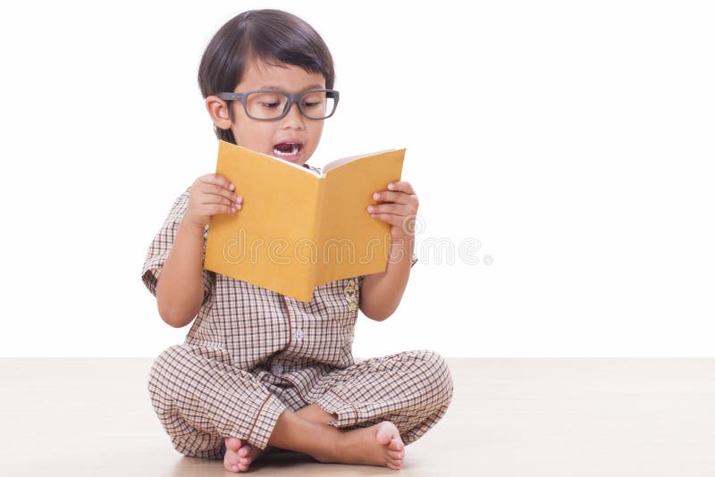Cute boy is reading a book stock image. Image of people - 41465545