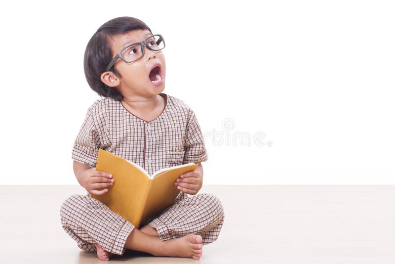 Cute boy is reading a book stock photo. Image of brunette - 41465580