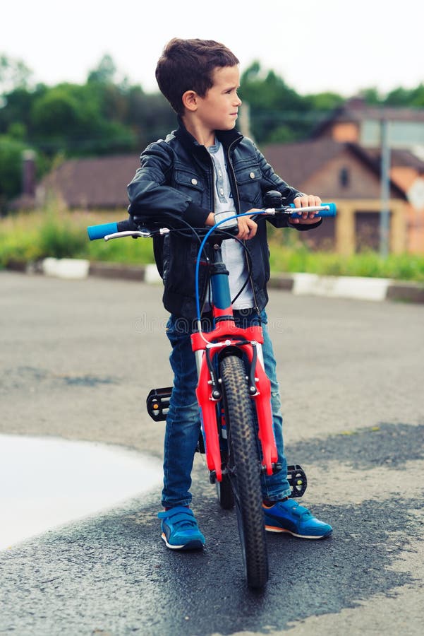 Cute boy riding a bike stock image. Image of cute, playful - 76781481