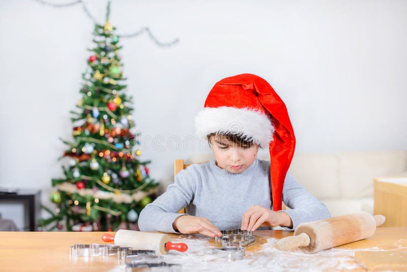 Cute Boy is Rolling Dough for Christmas Cookies Stock Photo - Image of ...