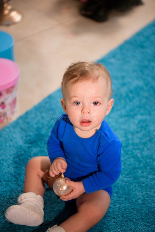 Cute Boy Sitting on the Carpet Near Christmas Tree Stock Photo - Image ...