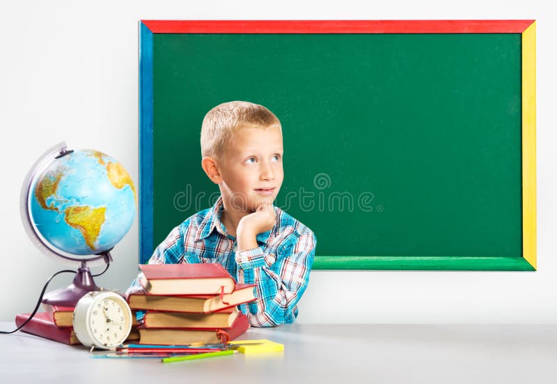 Cute Boy Sitting At The School Table Stock Photo - Image of planet ...