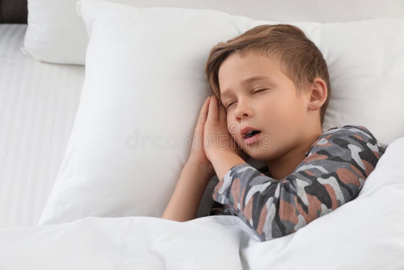 Cute boy sleeping in bed stock photo. Image of funny - 142457870