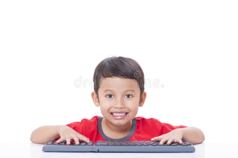 Cute Boy using a keyboard stock image. Image of education - 45642727