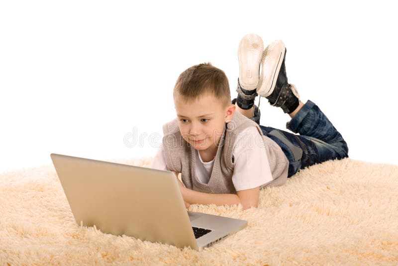 Cute boy using a laptop stock image. Image of learn, lying - 23819309