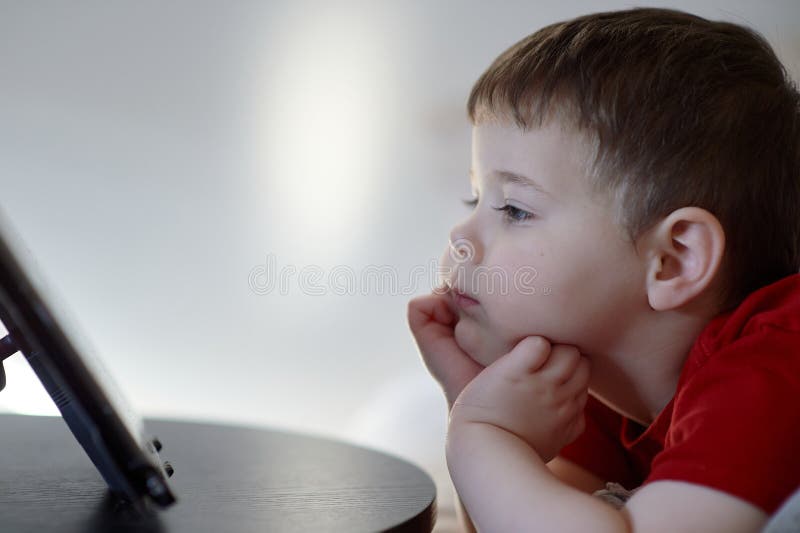 Cute Boy Watching Cartoons on a Table Top Tablet Stock Photo - Image of ...